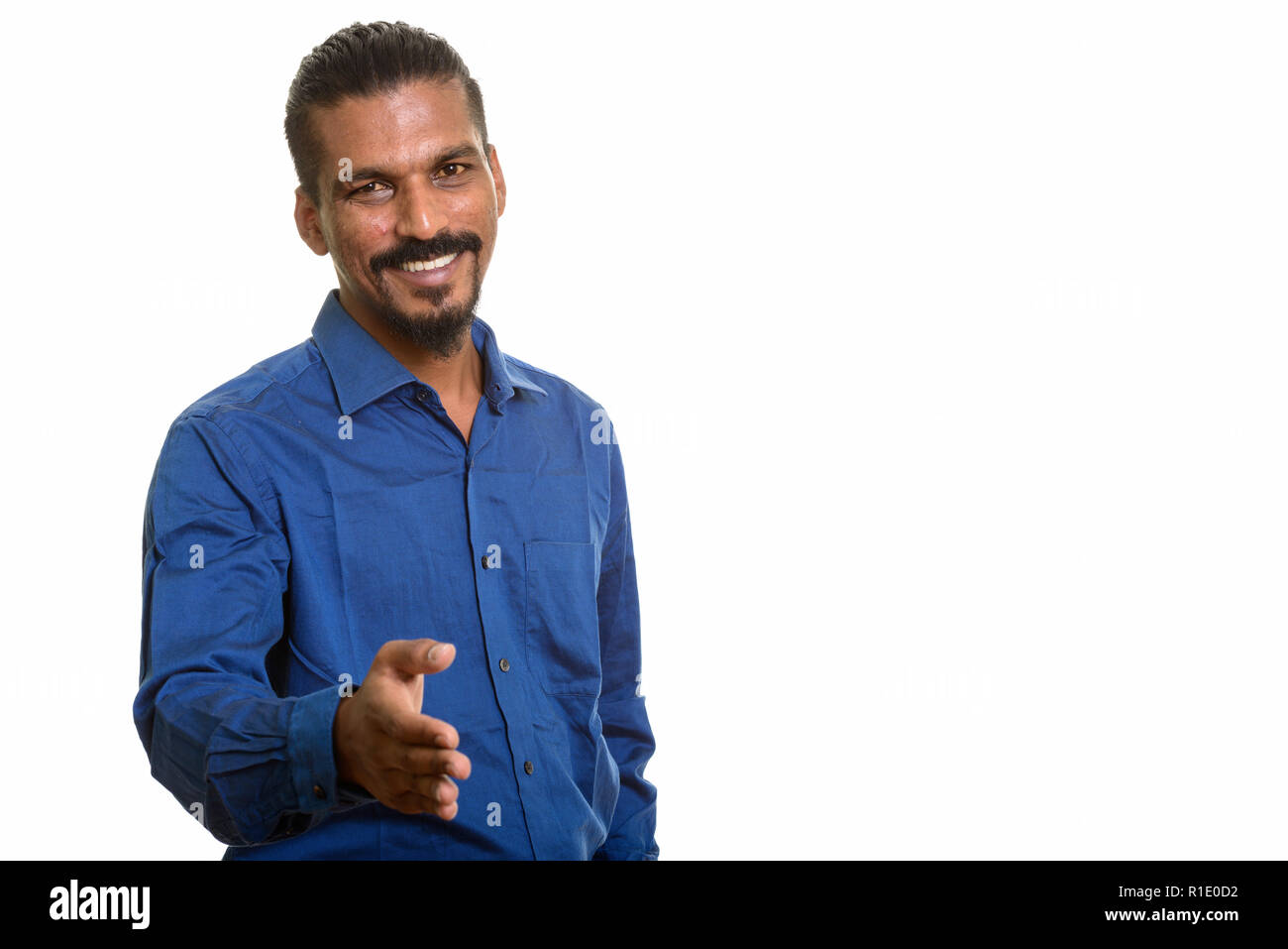 Young happy Indian businessman giving handshake studio portrait against ...