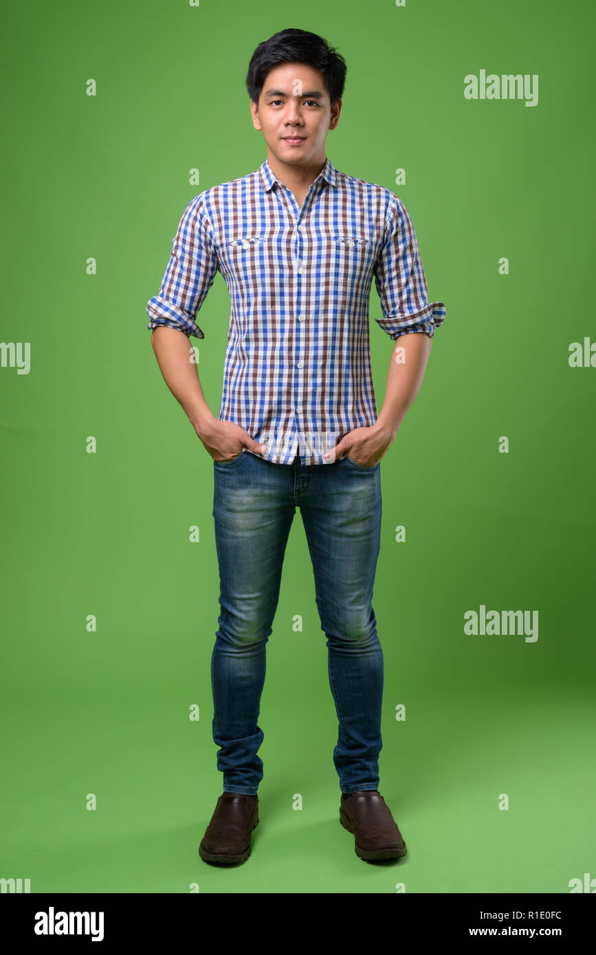 Young handsome Filipino man against green background Stock Photo - Alamy