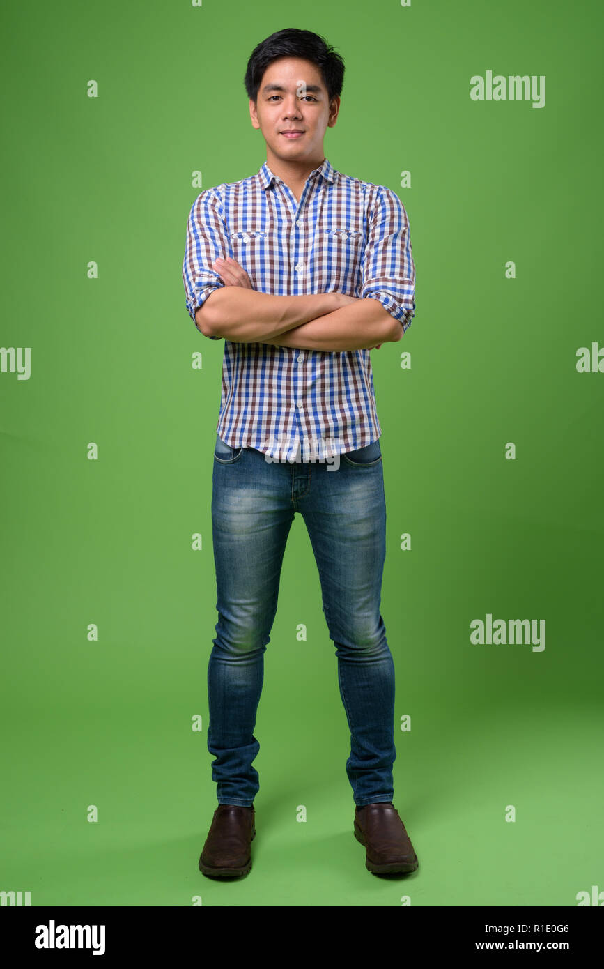 Young handsome Filipino man against green background Stock Photo - Alamy