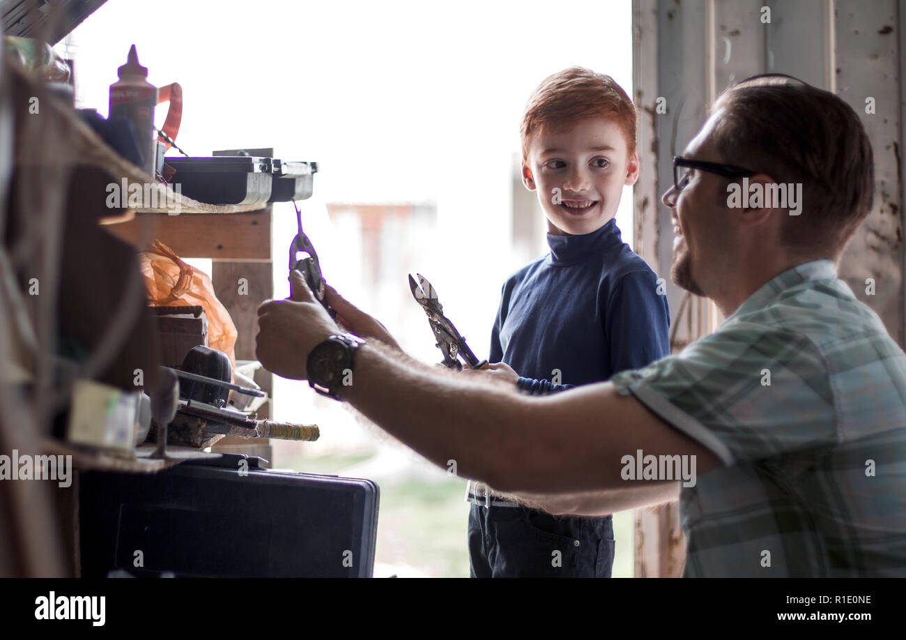 father and son work together in the home workshop Stock Photo - Alamy