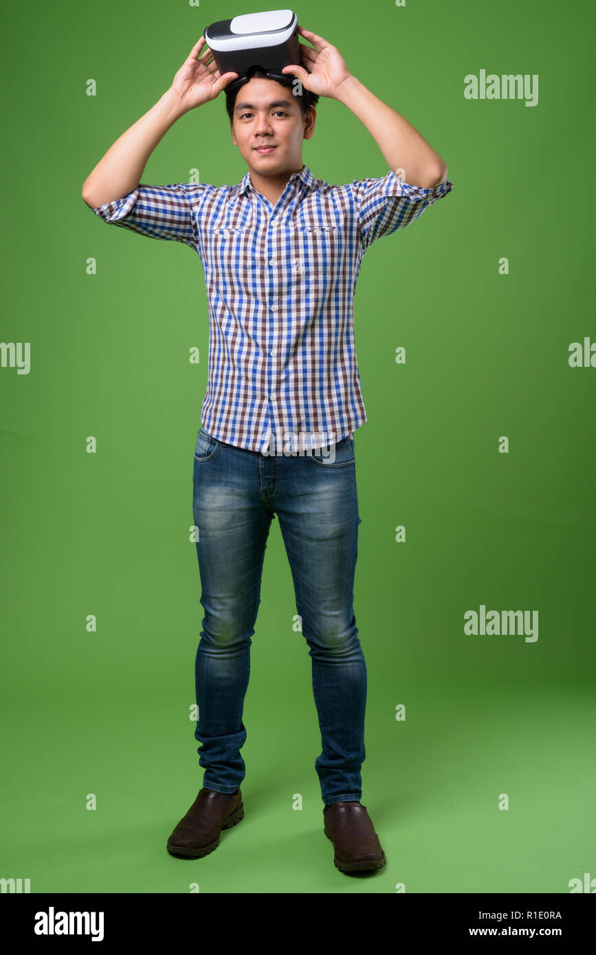 Young handsome Filipino man against green background Stock Photo - Alamy