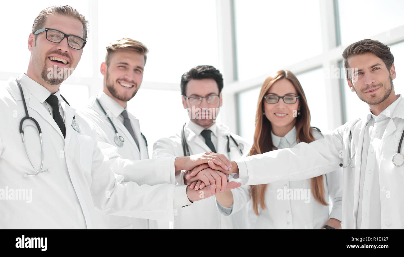 group of doctors with their hands folded together Stock Photo - Alamy