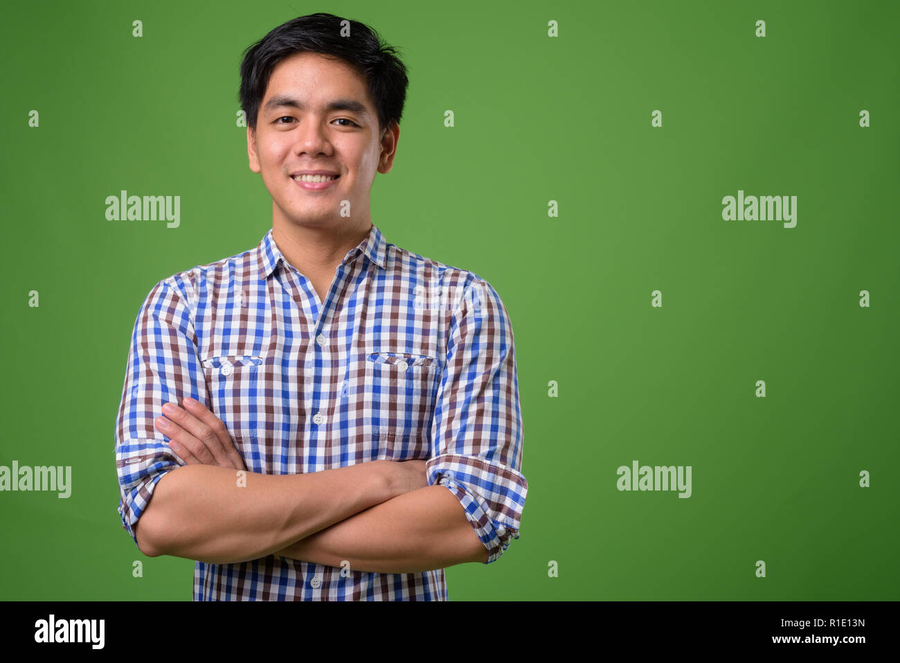Young handsome Filipino man against green background Stock Photo - Alamy