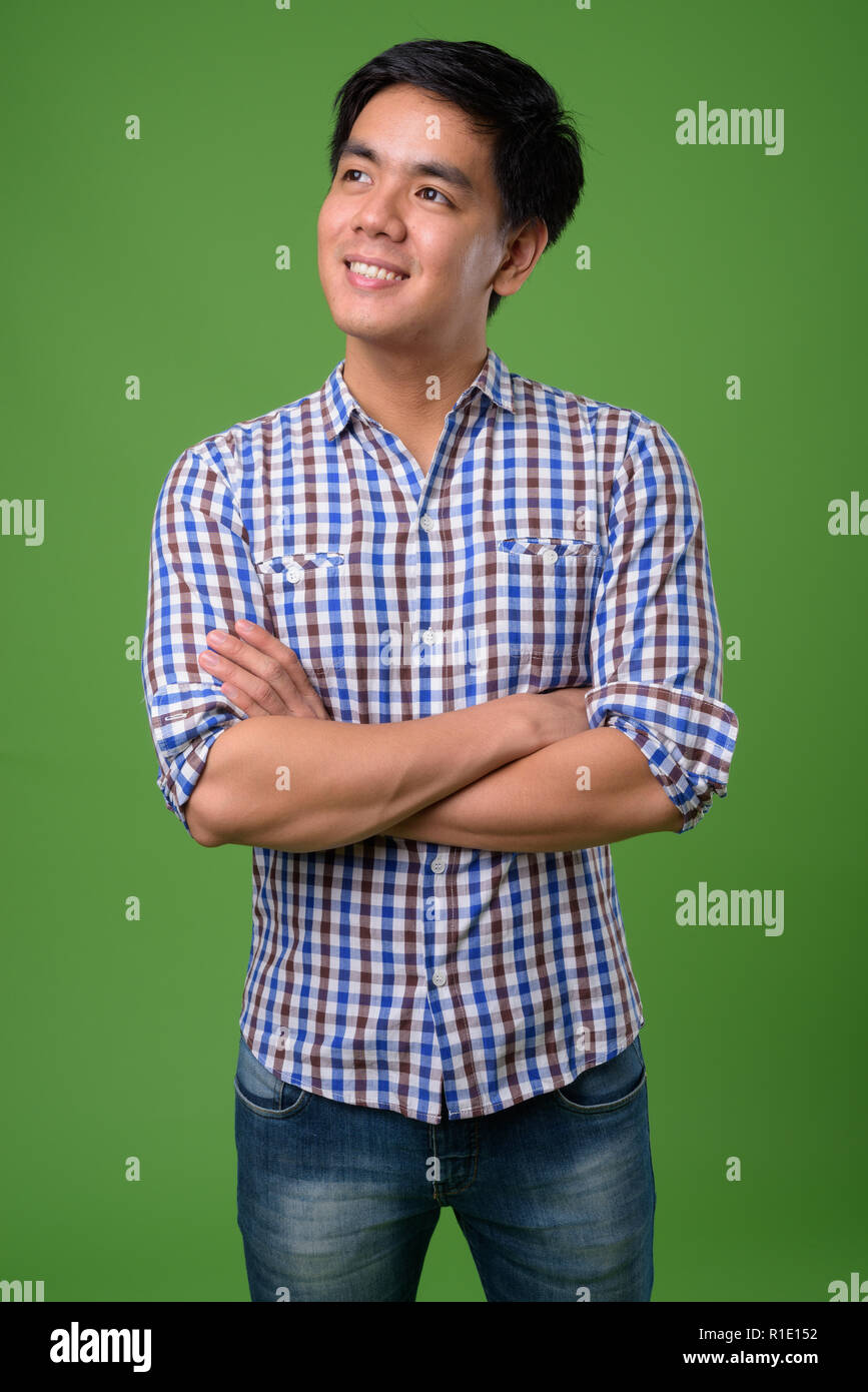 Young handsome Filipino man against green background Stock Photo - Alamy