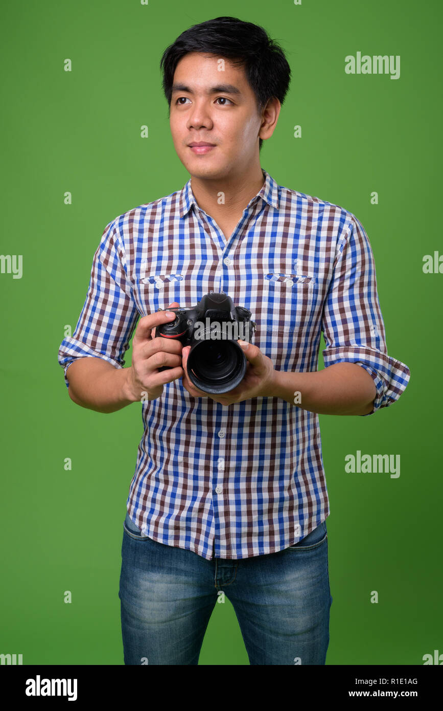 Young handsome Filipino man against green background Stock Photo - Alamy
