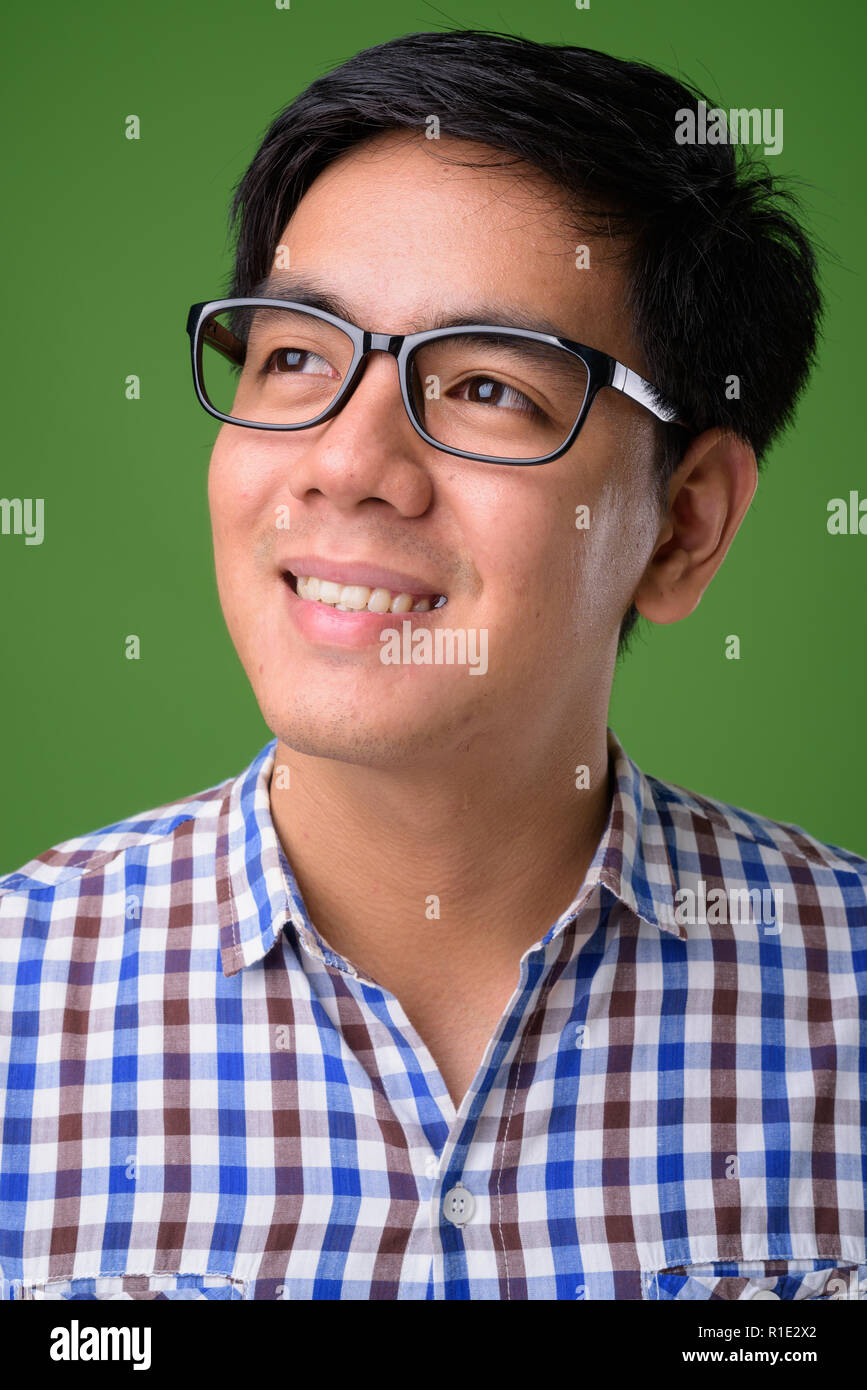 Young handsome Filipino man against green background Stock Photo - Alamy