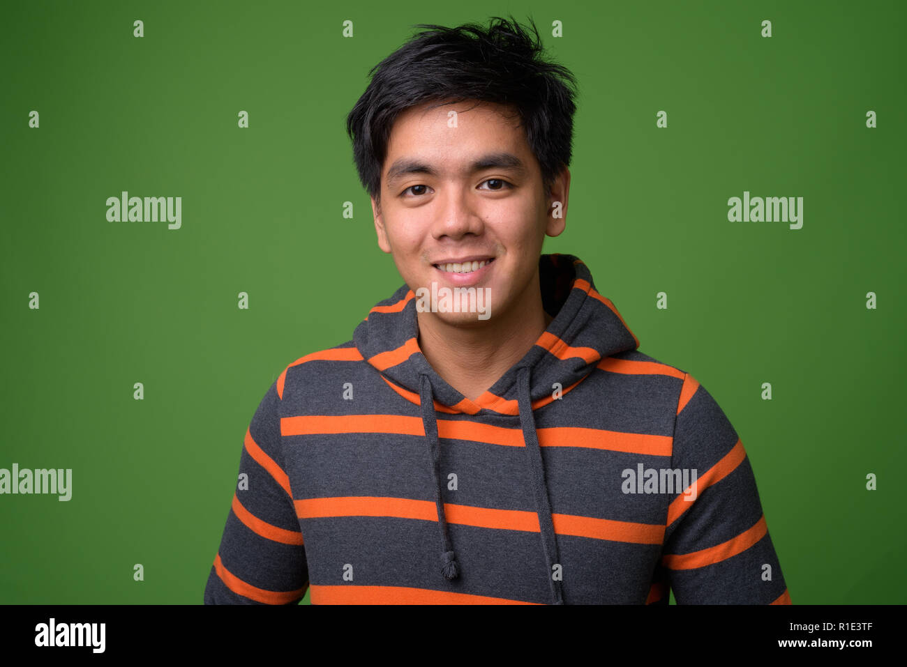 Young handsome Filipino man against green background Stock Photo - Alamy