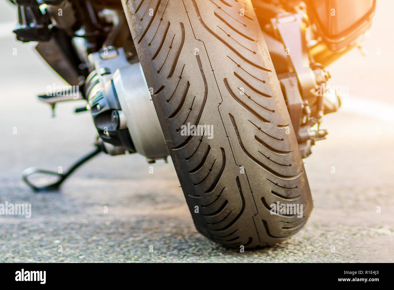 Rear wheel of sports motorcycle on road. Motorbike parked on a street ...