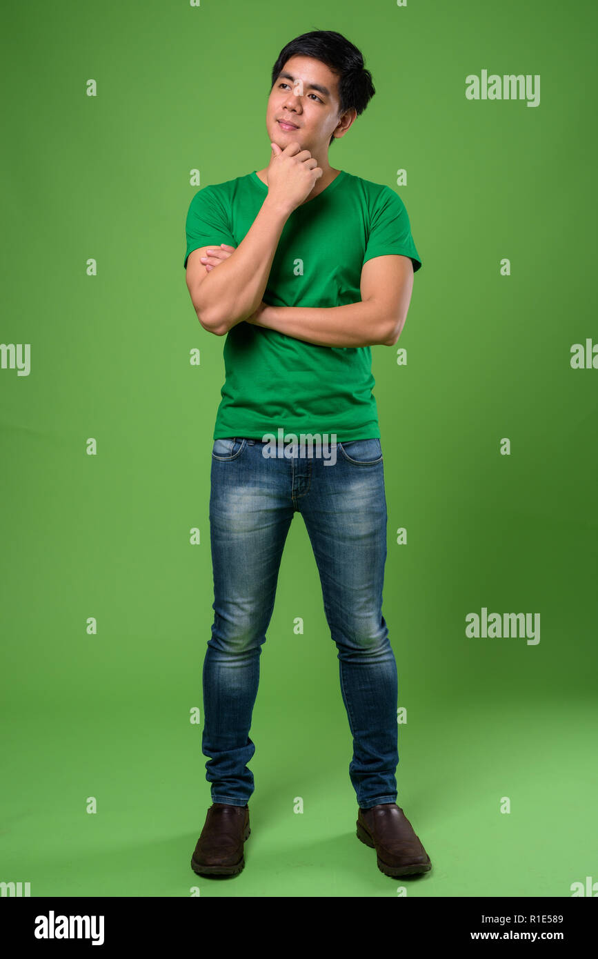 Young handsome Filipino man against green background Stock Photo - Alamy