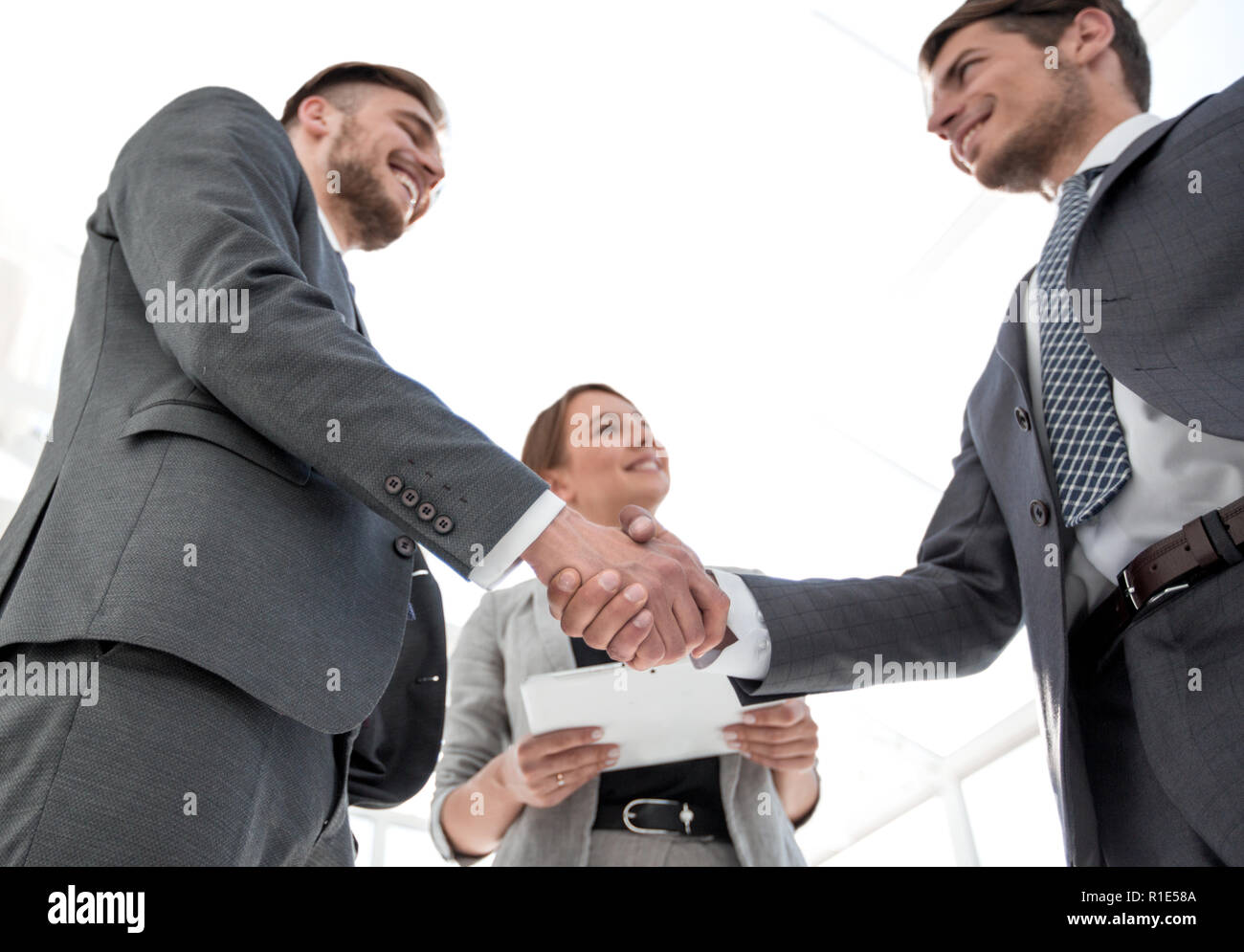 bottom view.handshake business partners standing in the office Stock Photo - Alamy