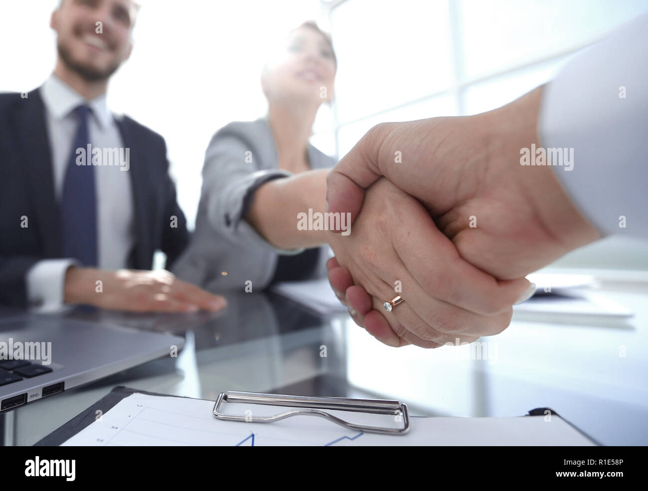 smiling business partners greeting each other Stock Photo - Alamy