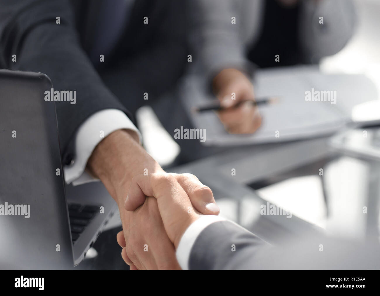 background image of business handshake over the Desk Stock Photo - Alamy