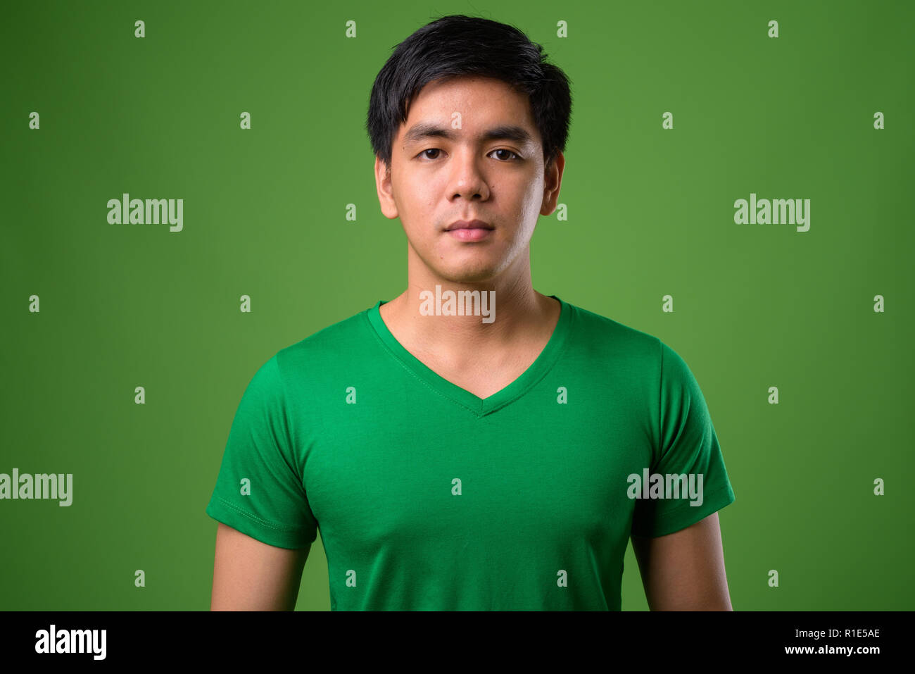 Young handsome Filipino man against green background Stock Photo - Alamy