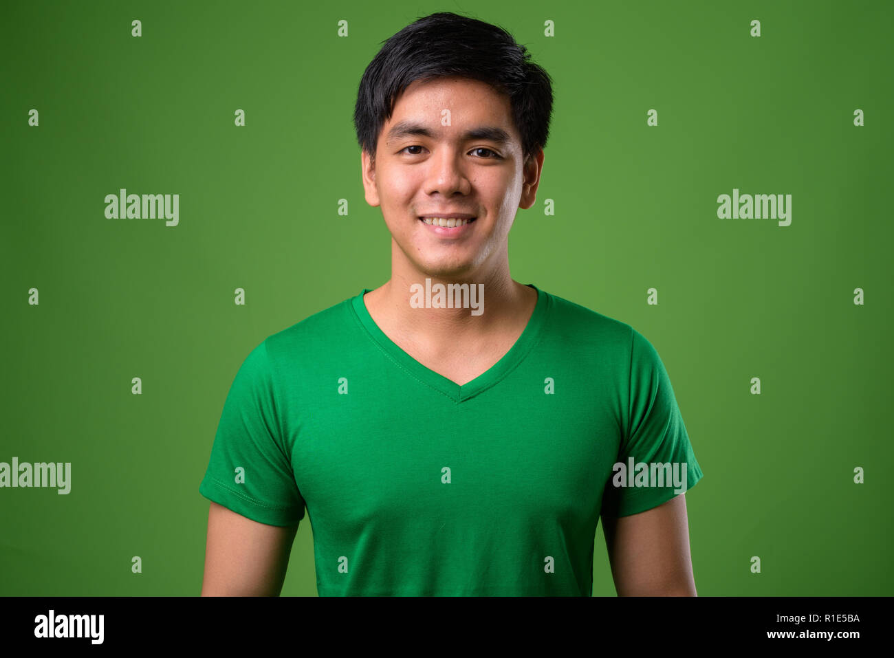 Young handsome Filipino man against green background Stock Photo - Alamy