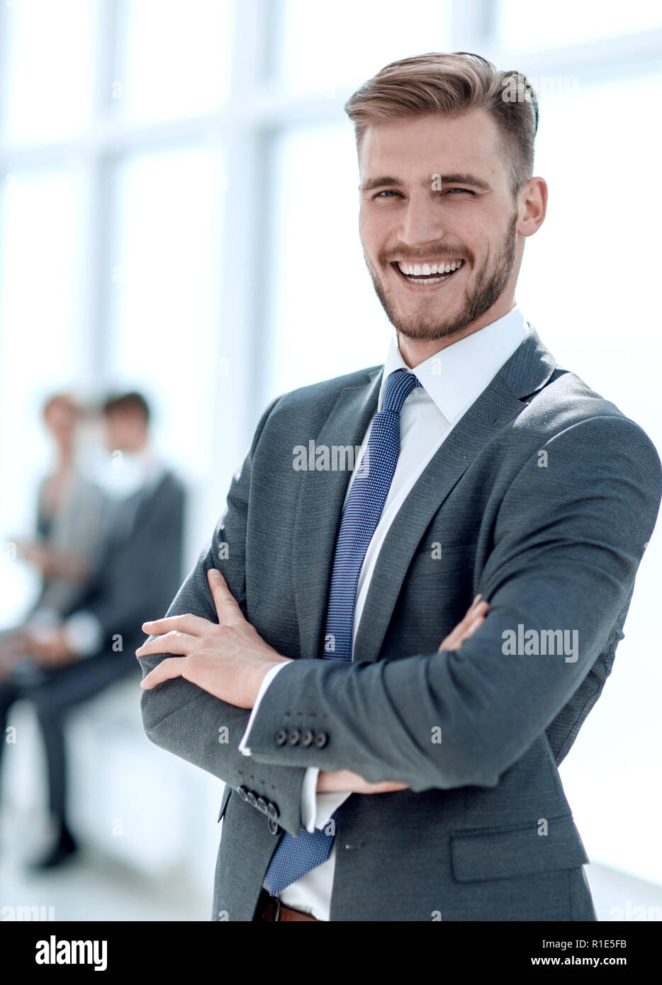 successful businessman on the background of a bright office Stock Photo ...