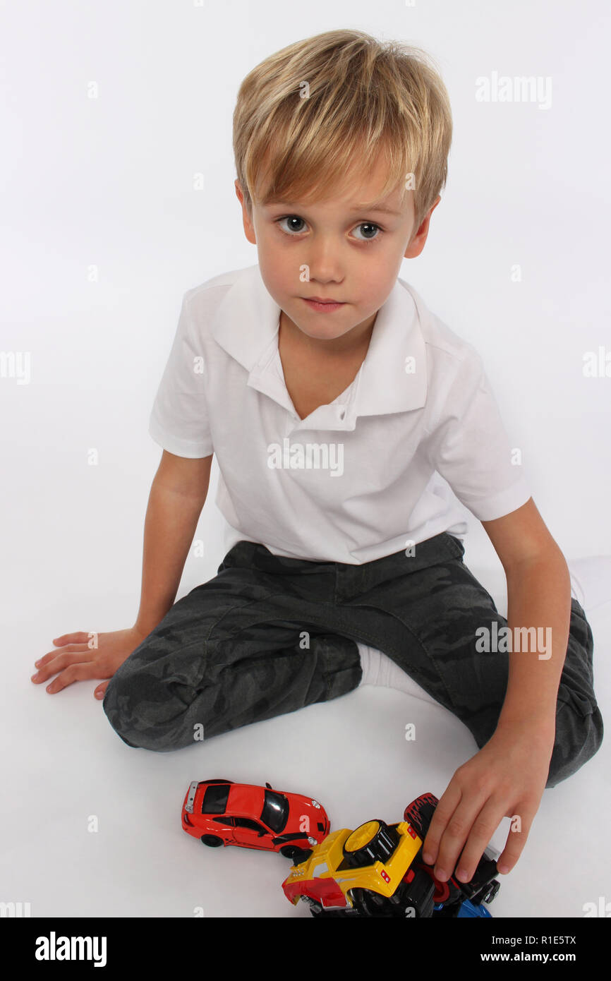 Small handsome boy playing with toys Stock Photo - Alamy