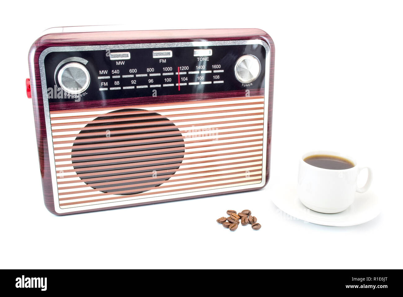 cup of coffee next to the old radio and coffee beans isolated on white ...