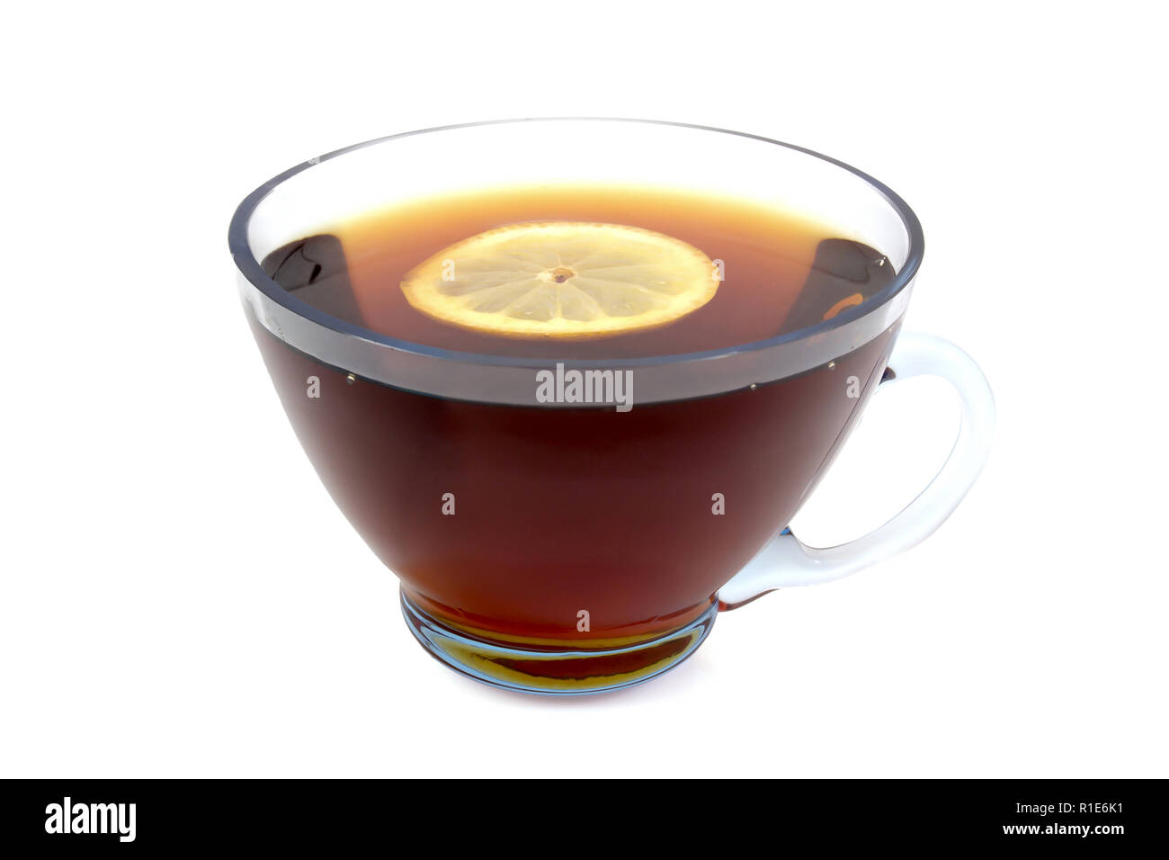 beautiful transparent cup of tea with a slice of lemon and whole lemon ...
