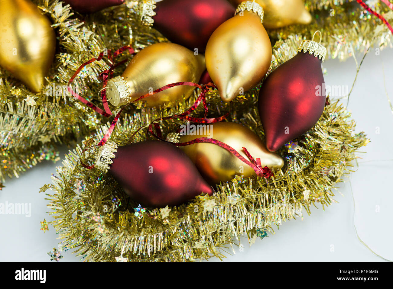 Red and gold Christmas baubles on gold tinsel Stock Photo - Alamy