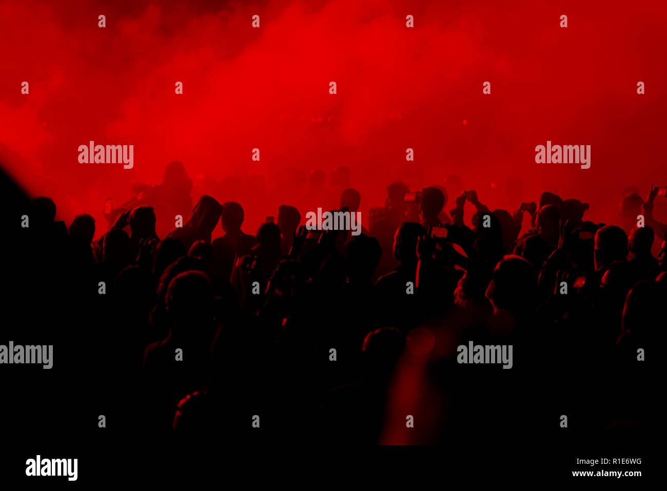 Concert field, crowded people under the red stage lights Stock Photo ...