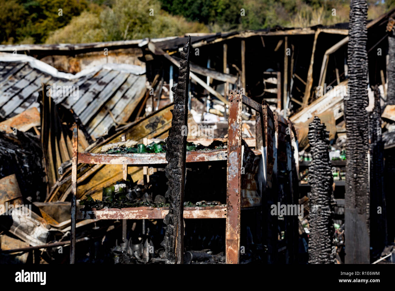 Close up damaged supermarket glass plastic bottles on shelves after ...