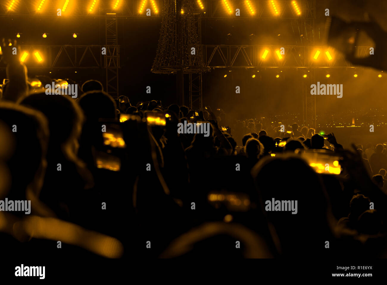 Concert field, crowded people and yellow stage lights with smoke Stock ...