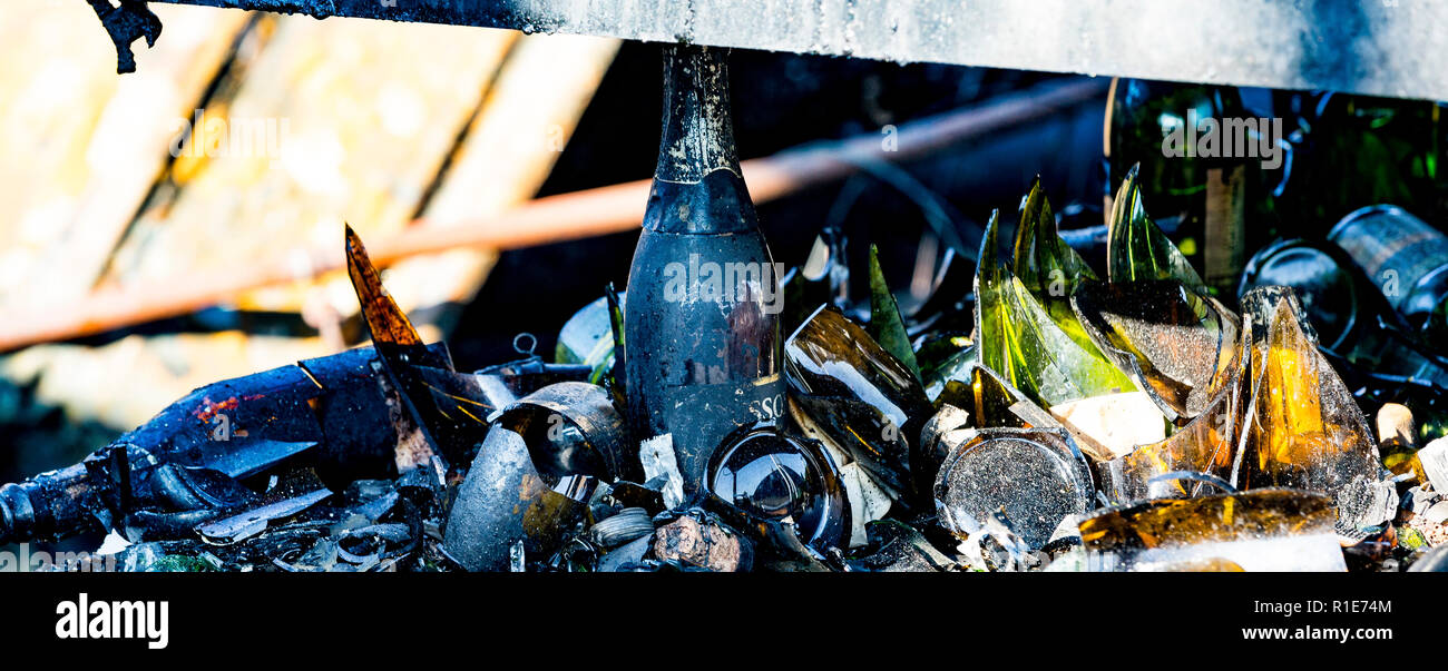 Close up damaged supermarket glass plastic bottles after arson fire ...
