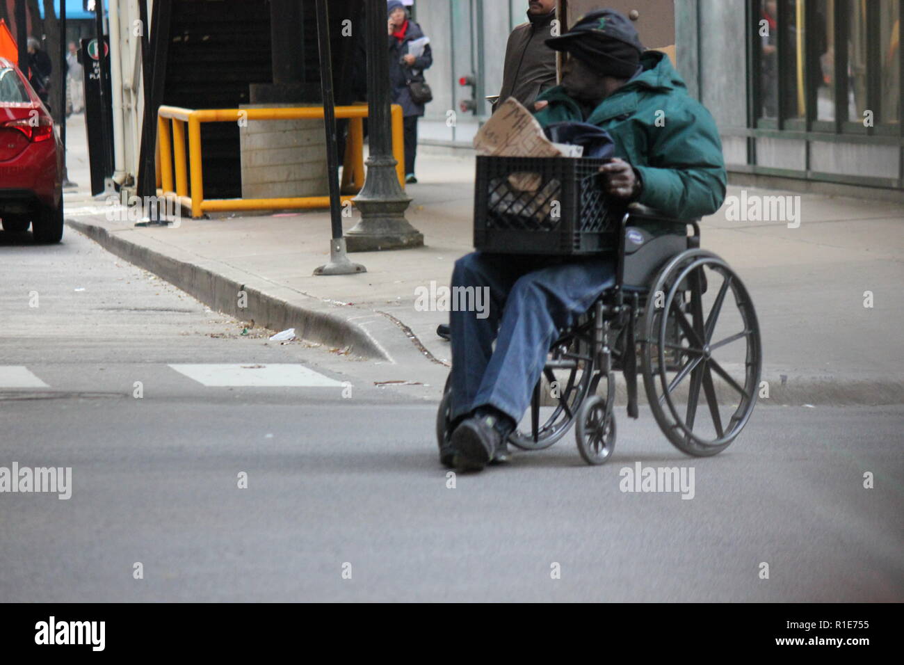 Down and out homeless man riding in a wheelchair trying to survive on ...