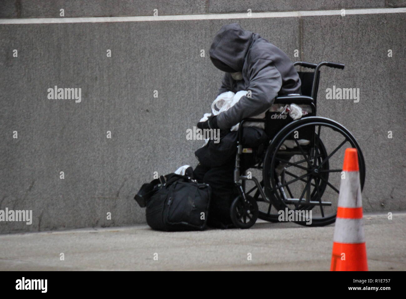 Down and out homeless man riding in a wheelchair trying to survive on ...