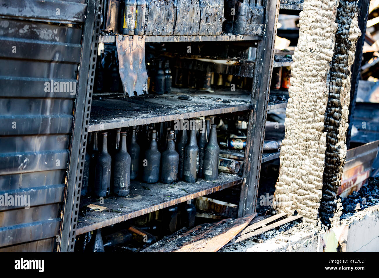 Close up damaged supermarket glass plastic bottles on shelves after ...