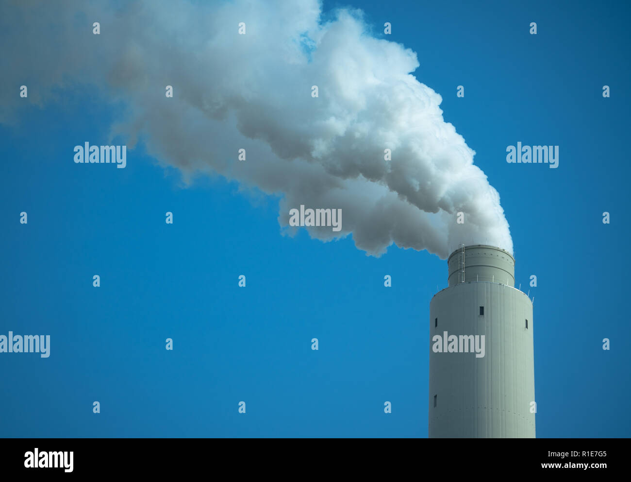 Smoke stack close up, white smoke against blue sky landscape ...