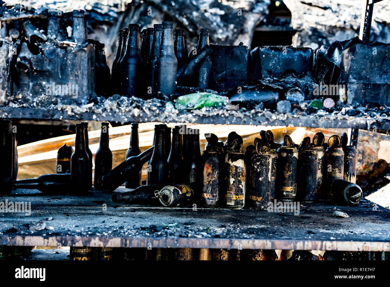 Close up damaged supermarket glass plastic bottles after arson fire ...