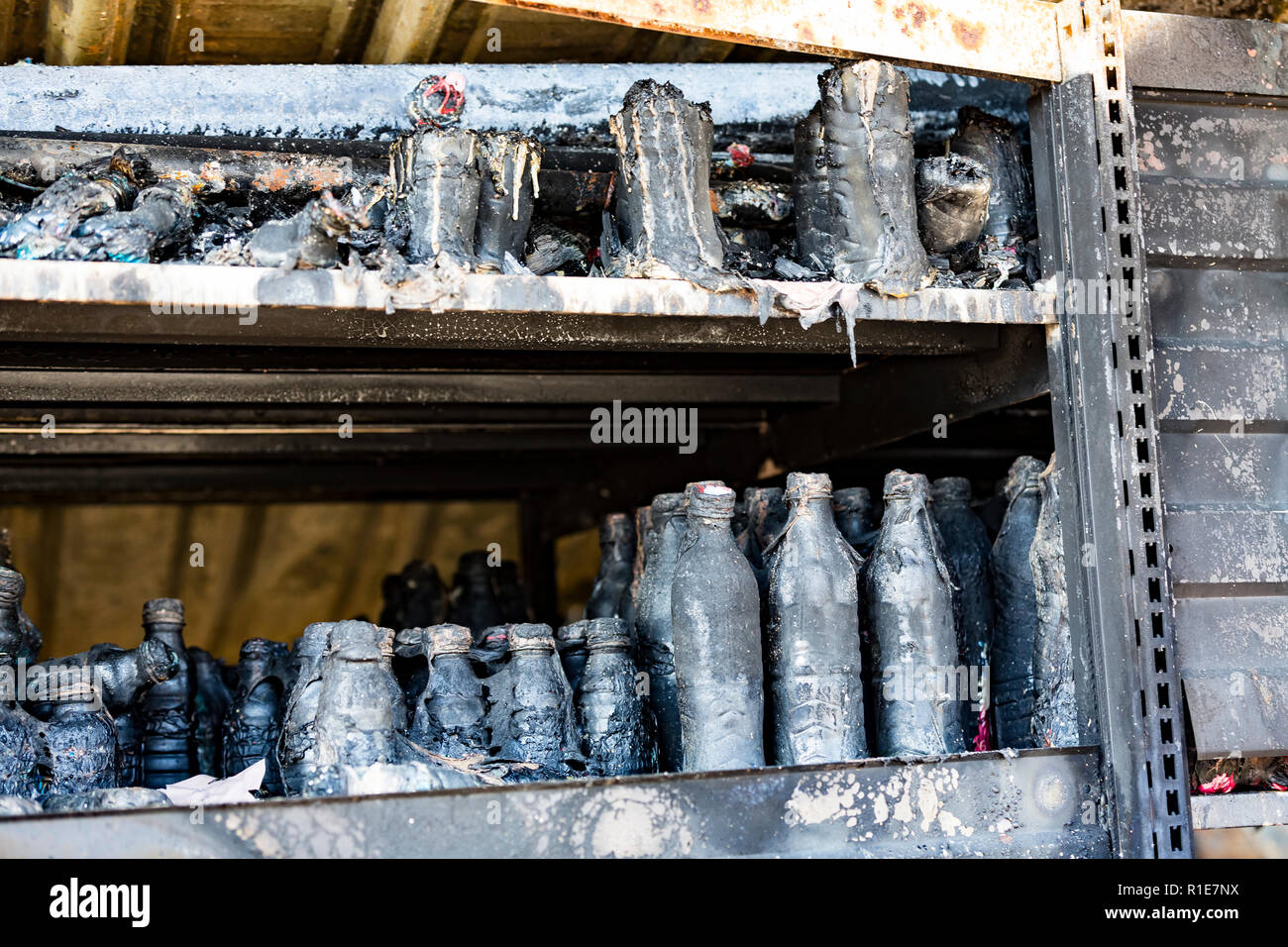 Close up damaged supermarket glass plastic bottles on shelves after ...
