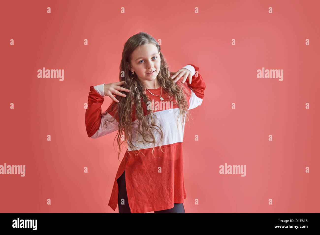 Young beautiful cute girl dancing on red background, modern slim hip ...