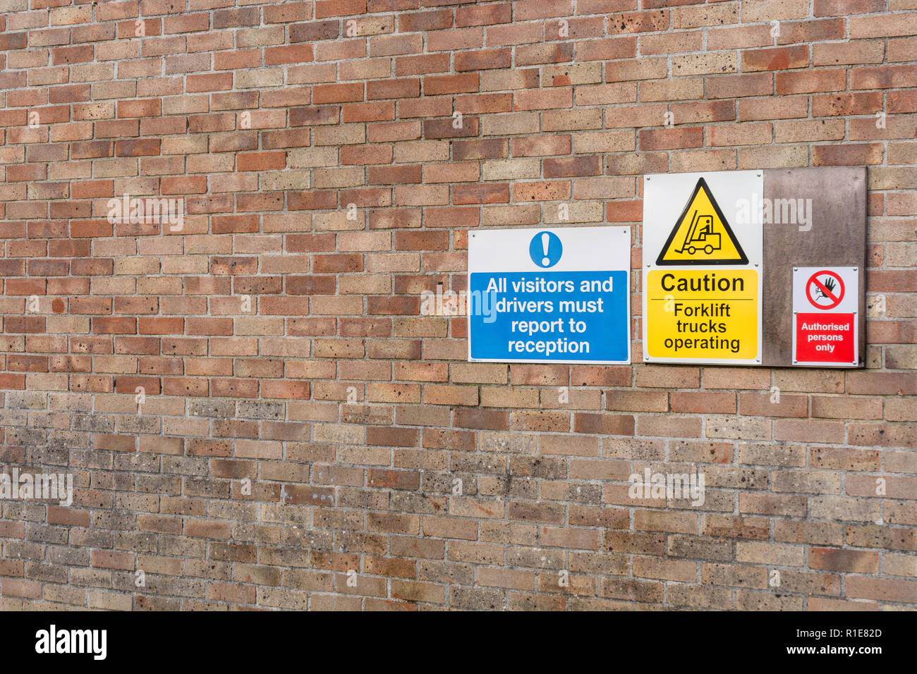 External factory wall with Health & Safety forklift truck and personnel ...