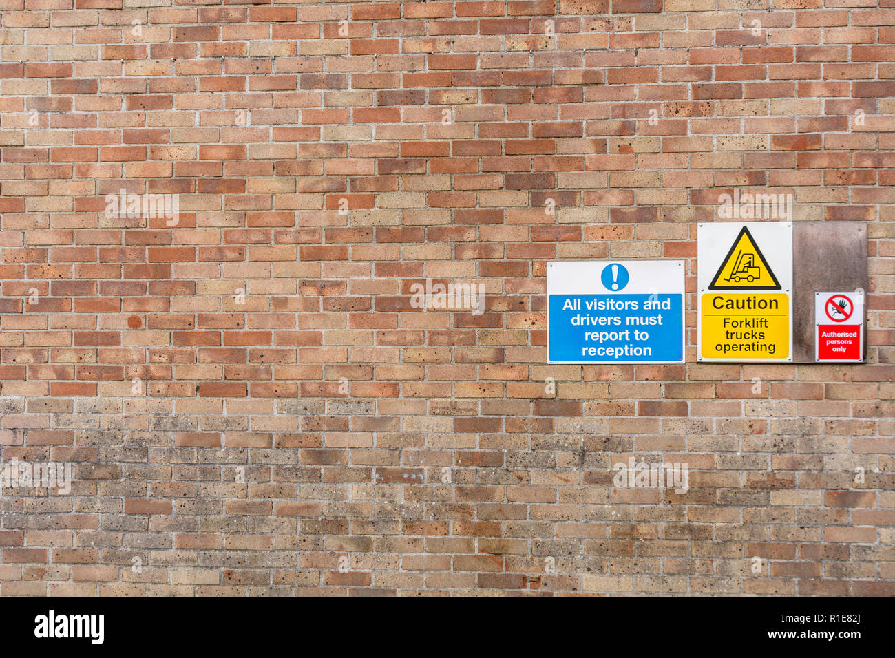 External factory wall with Health & Safety forklift truck and personnel ...