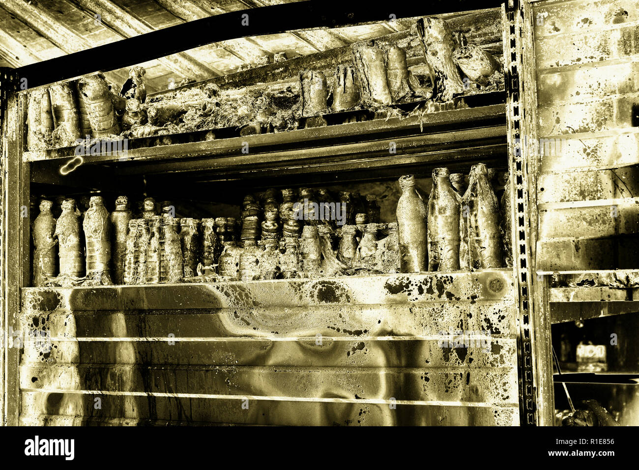 Close up damaged supermarket glass plastic bottles after arson fire ...