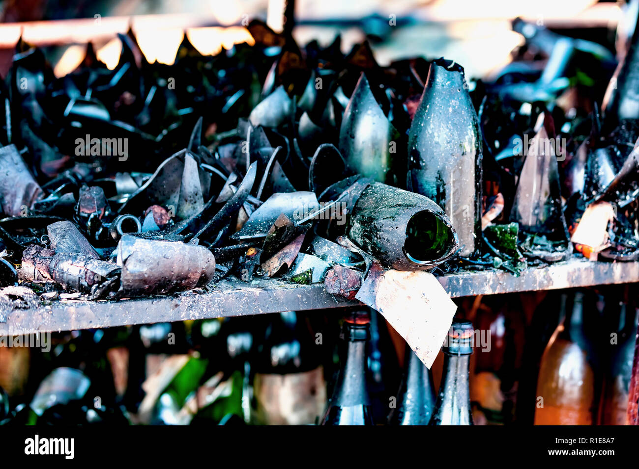 Close up damaged supermarket glass plastic bottles after arson fire ...
