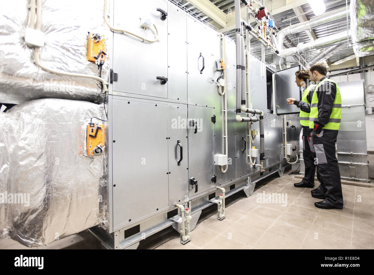 Workers in electrical switchgear room of CNC plant Stock Photo - Alamy