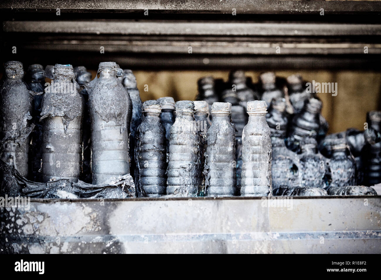 Close up damaged supermarket glass plastic bottles on shelves after ...