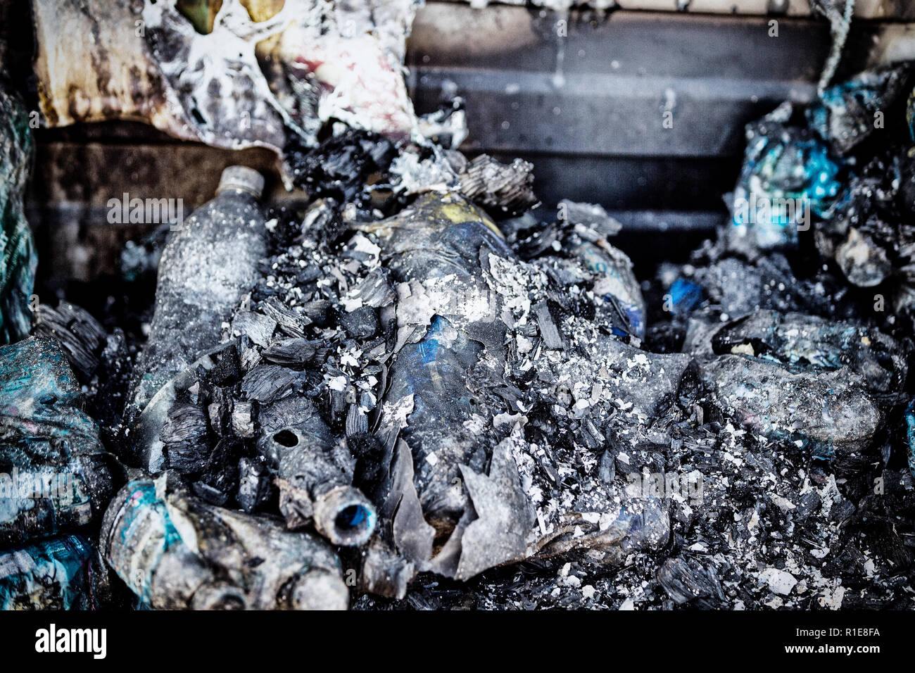 Close up damaged supermarket glass plastic bottles after arson fire ...