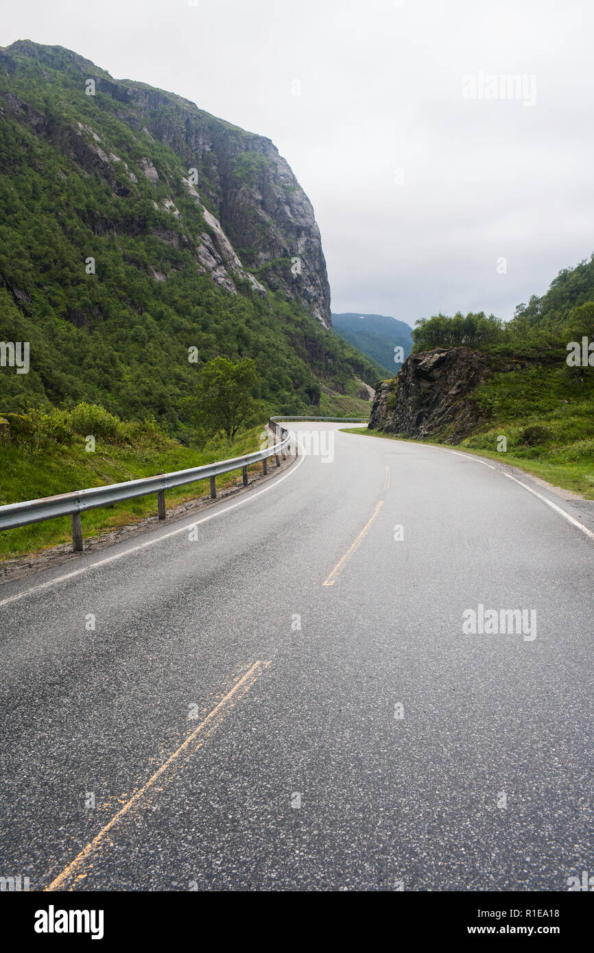 Mountain road. Landscape with rocks, sunny sky with clouds and ...