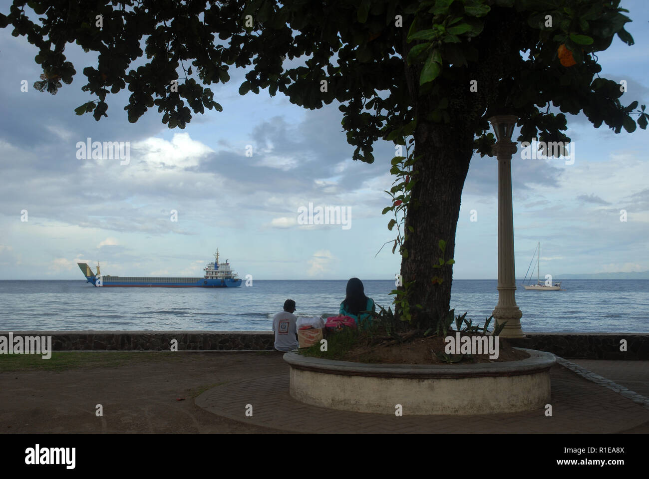 People sat on bench, Flores Ave Piapi, Escano Beach, Dumaguete, Negros ...
