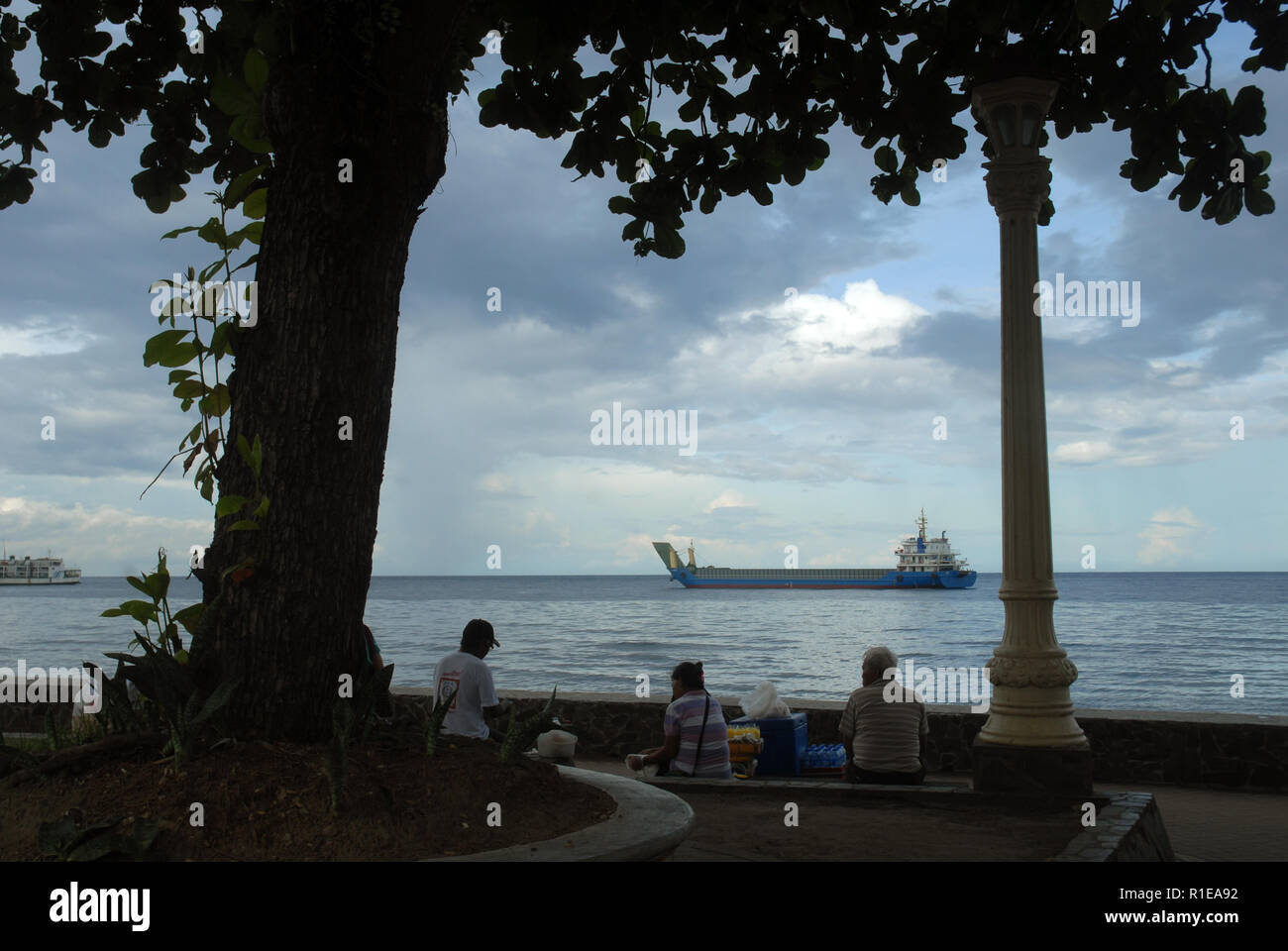 People sat on bench, Flores Ave Piapi, Escano Beach, Dumaguete, Negros ...