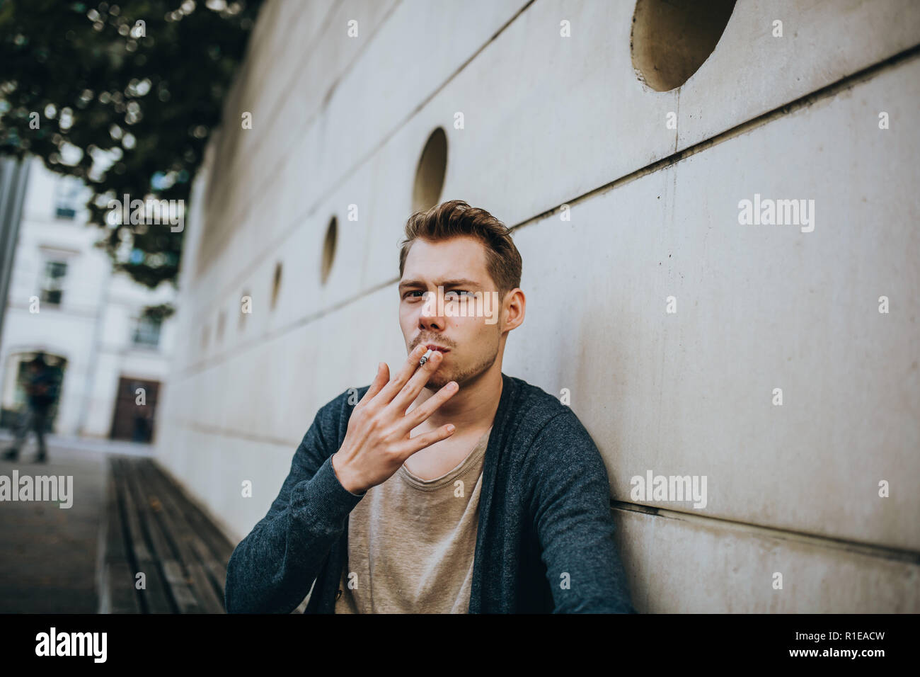 photo of a face of a young man who smokes a cigarette Stock Photo - Alamy