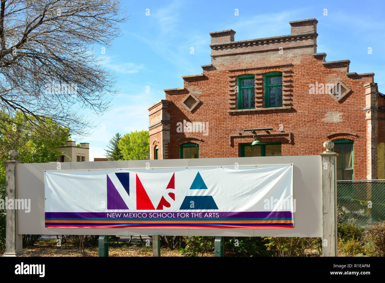 A banner for the New Mexico School for the Arts hangs in front of an ...