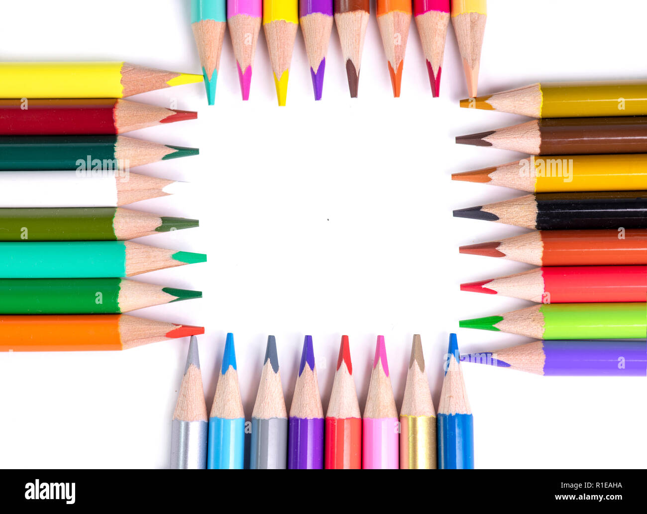 different colored pencils arrange in a square for copy space and text ...