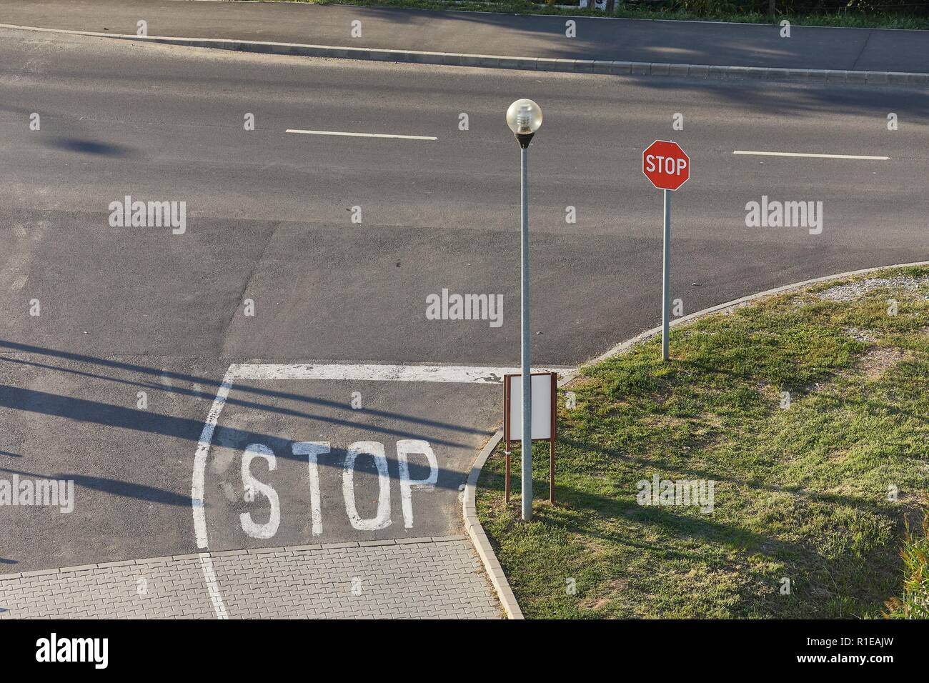 Stop sign at an intersection Stock Photo - Alamy