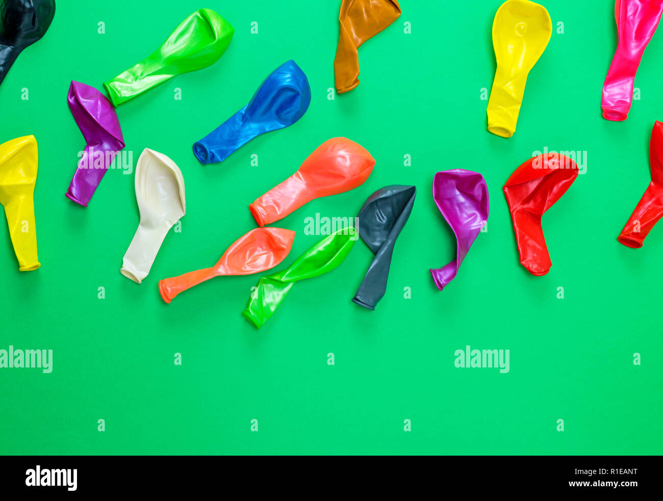 colorful deflated balloons on a green background, copy space Stock ...