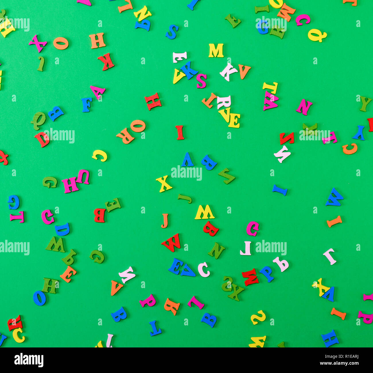 small wooden multi-colored letters of the English alphabet are ...